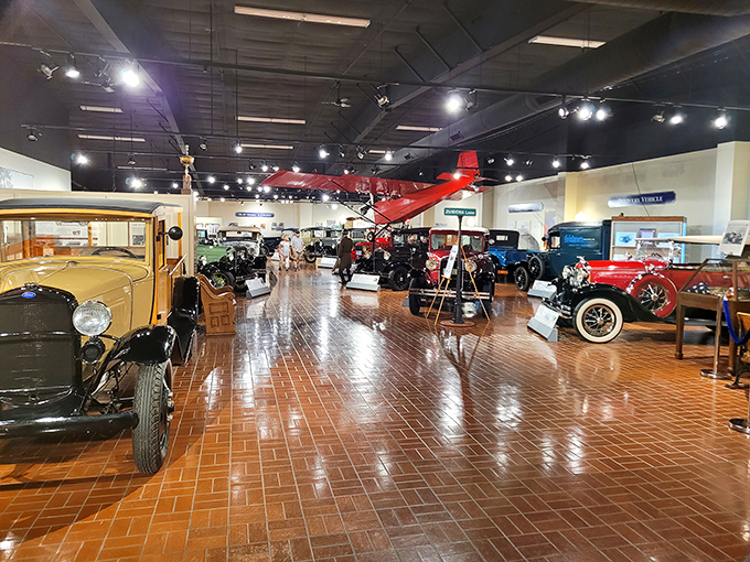 Classic cars share space with a vintage aircraft, proving that the spirit of innovation knows no bounds at this comprehensive museum.