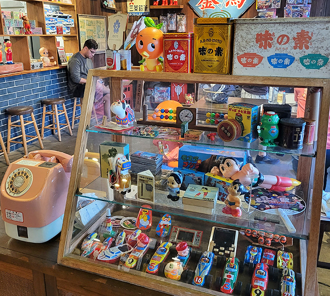 A display of retro Japanese toys adds playful nostalgia to the restaurant&rsquo;s lively atmosphere.
