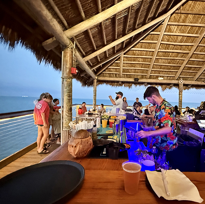 The tavern buzzes with conversation and laughter as patrons gather around the bar, proving that happiness is indeed a place on a map.