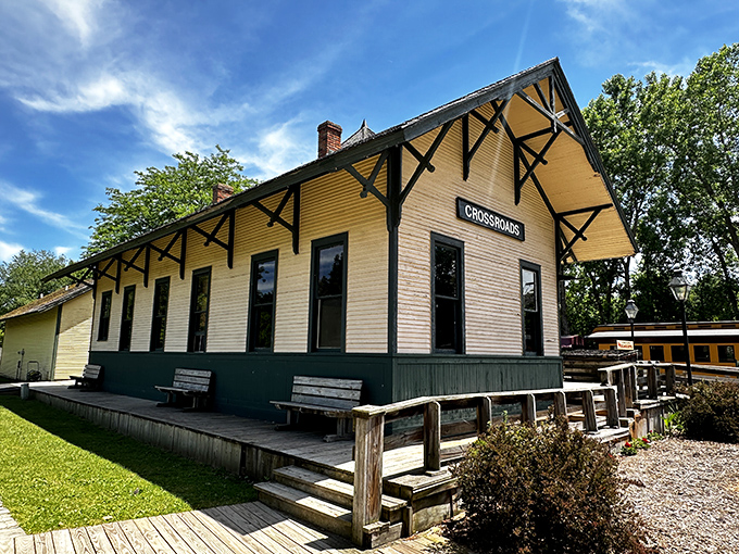 The Crossroads station, painted in cheerful yellow, serves as both a practical depot and a time portal to America's golden age of rail.