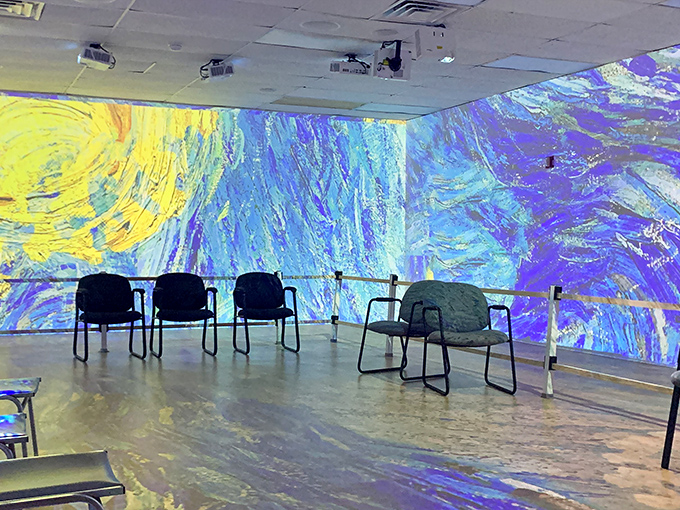The world's most famous swirling sky is right here! Van Gogh's Starry Night completely washes over the room in vivid color.