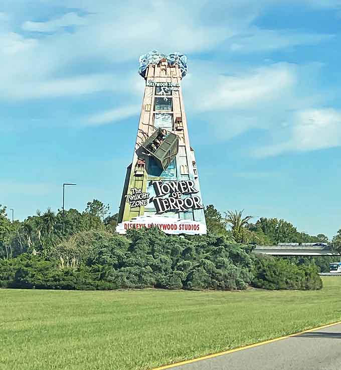 The Tower of Terror looms ominously against blue skies, its weathered exterior promising a drop that'll rearrange your internal organs.