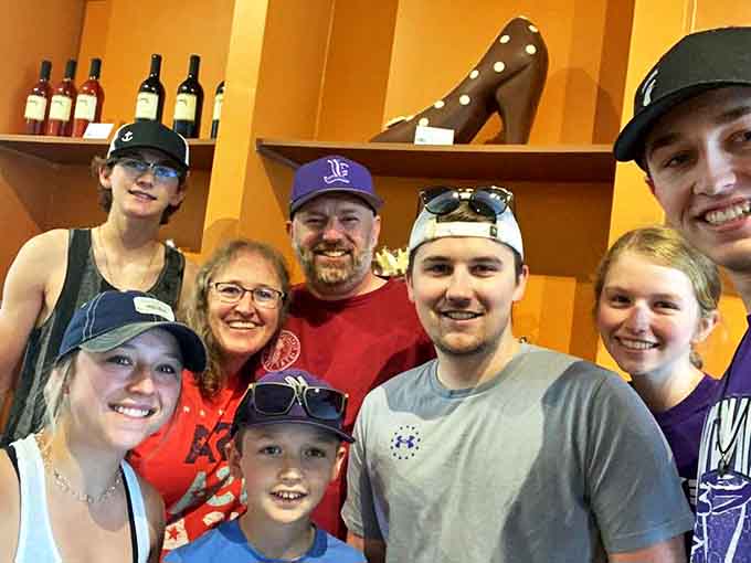 Happy visitors gather for a chocolate kingdom memory – their smiles suggesting they've found the sweetest spot in Orlando.