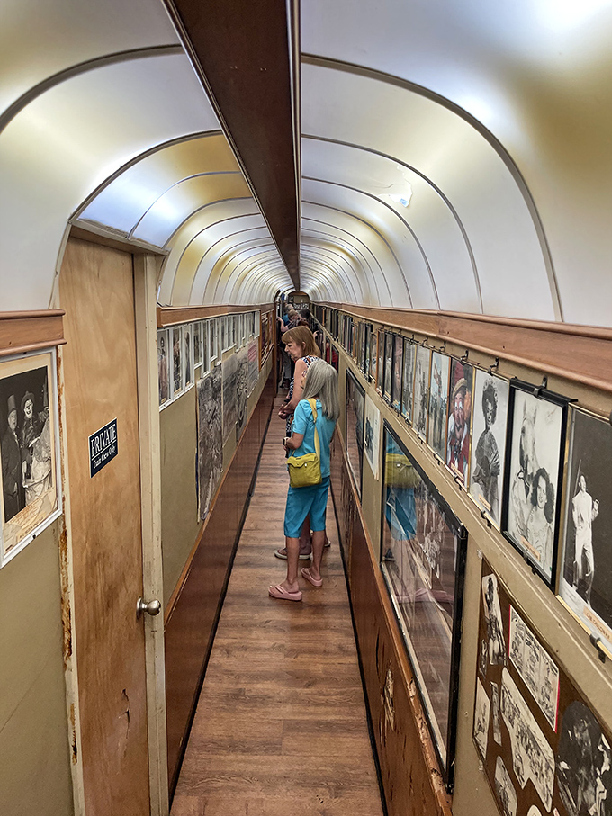 The narrow corridor between cars creates an immersive museum experience, walls lined with circus history that captivates between courses.