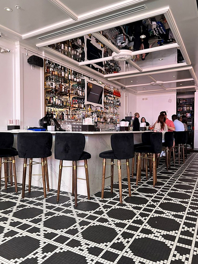 The bar glows with backlit bottles like a beacon for those seeking liquid desserts that bubble, smoke, and occasionally change color.