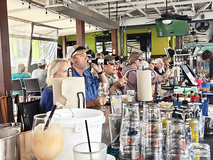 The bar area serves up cold drinks and warm conversation, where locals and visitors bond over their mutual appreciation for Gulf Coast treasures.