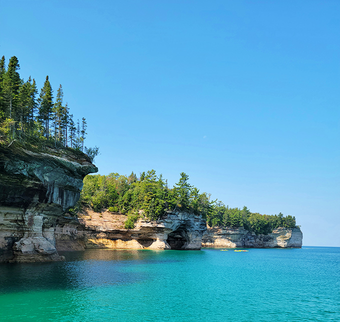 Layers of sedimentary history create nature's skyscrapers, their colorful striations revealing millions of years of geological storytelling.