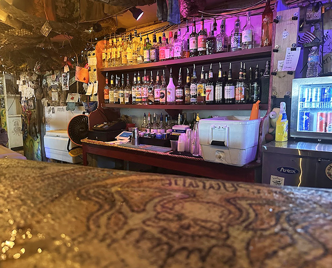 The bar itself is a masterpiece of organized chaos, where bartenders navigate the space with surprising grace and efficiency.