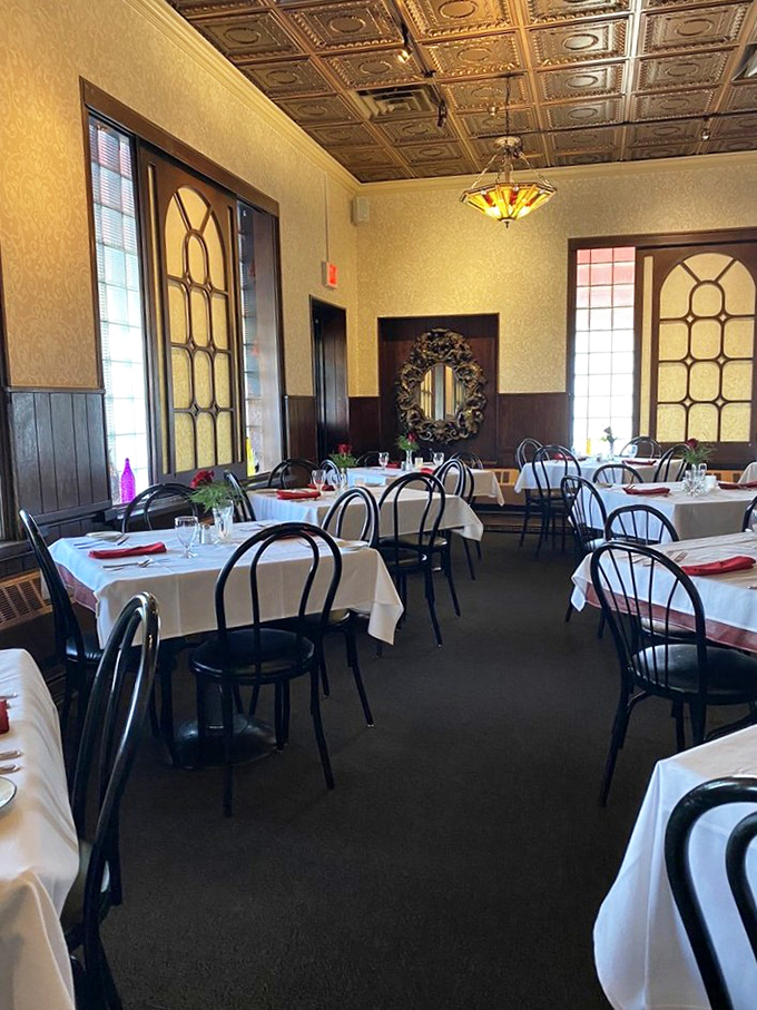 Dining Area: White tablecloths and elegant place settings await diners in this room where countless celebrations and quiet dinners have unfolded.