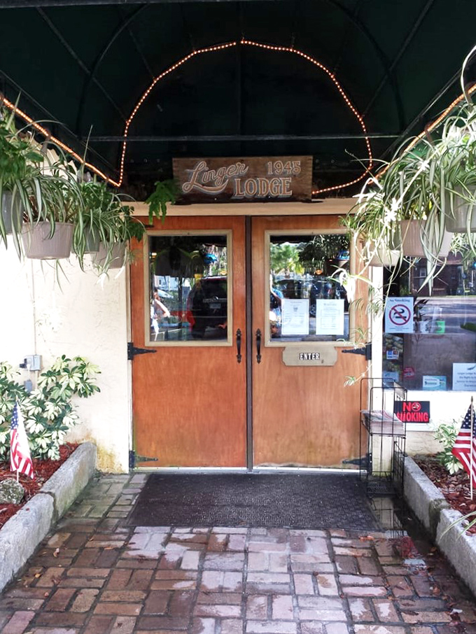 The welcoming entrance, framed by hanging plants and twinkling lights, invites you into a slice of Old Florida preserved in all its quirky glory.