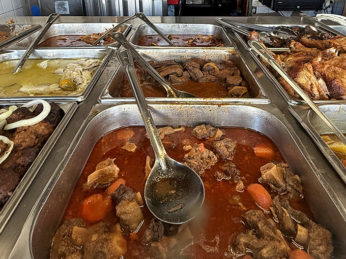 Steam rises from these trays like aromatic ghosts, each one holding treasures that represent generations of Caribbean cooking wisdom.