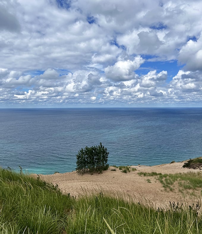 Glen Lake's brilliant blue waters peek through the forest canopy, a hidden gem waiting to be discovered.