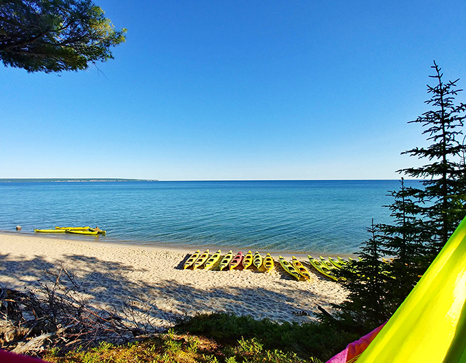 A rainbow of kayaks rests on pristine sand, waiting to transport adventurers across waters so clear they'll swear they're floating on air.