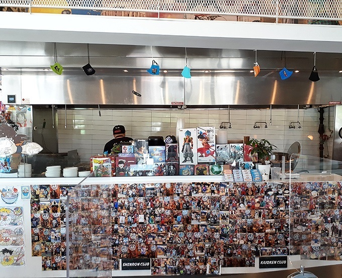 Behind the counter, culinary magic happens with the precision and flair of a well-choreographed anime battle sequence.