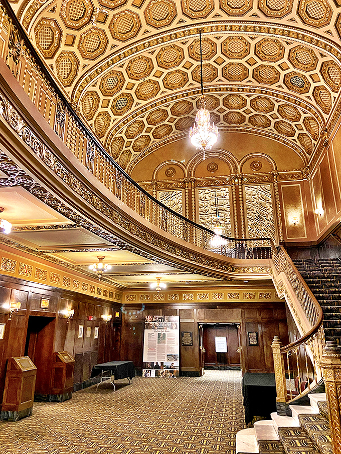The grand foyer's ceiling medallions and ornate moldings tell stories of craftsmanship from an era when theaters were built as palaces.