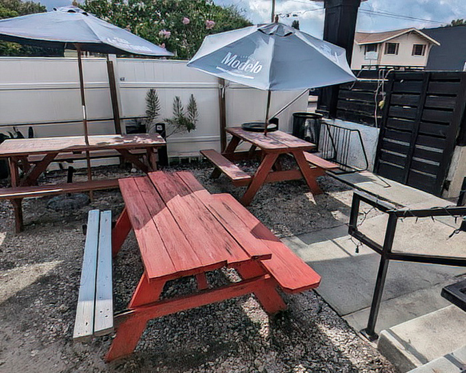 Sun-drenched picnic tables under Modelo umbrellas offer the perfect setting for that "I can't believe I ate the whole thing" moment of reflection.