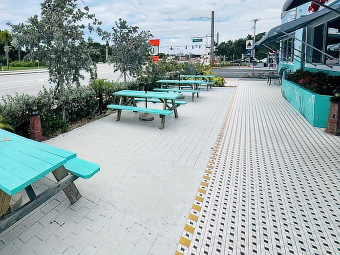 Turquoise picnic tables offer al fresco dining options for those perfect Florida mornings when the humidity takes a rare day off.