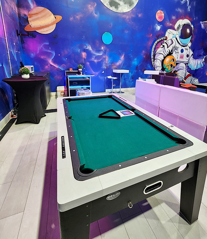 A pool table set against a space-themed backdrop offers a classic game with an intergalactic twist.