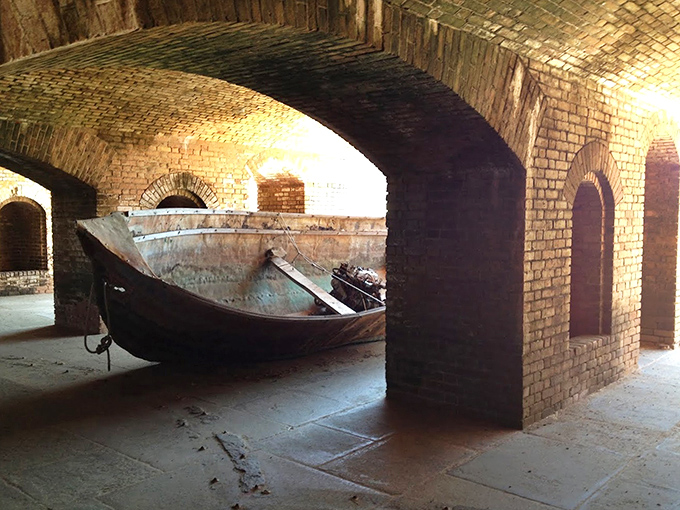 This weathered boat rests within the fort's walls, a silent storyteller of maritime adventures in these historic waters.