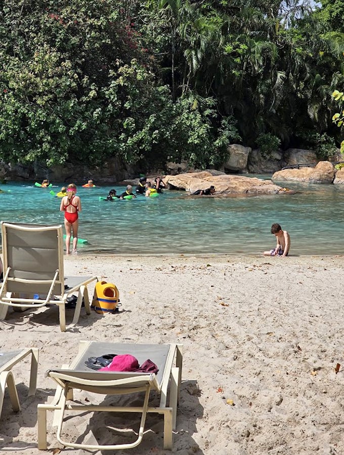 Beach chairs await sun-seekers on pristine sands, promising a perfect blend of relaxation and adventure just steps from the water.
