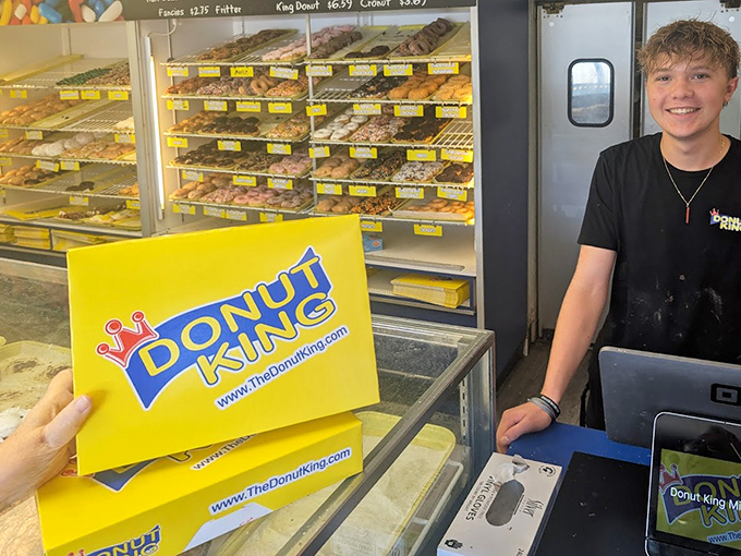 Behind the counter, friendly staff stand ready to help you navigate the important life decision of which donut to choose.