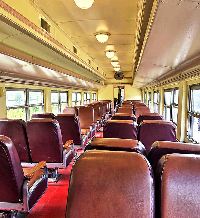 Vintage passenger train car: Rich burgundy seats line this meticulously preserved passenger car, where modern families can experience travel as their grandparents once did.