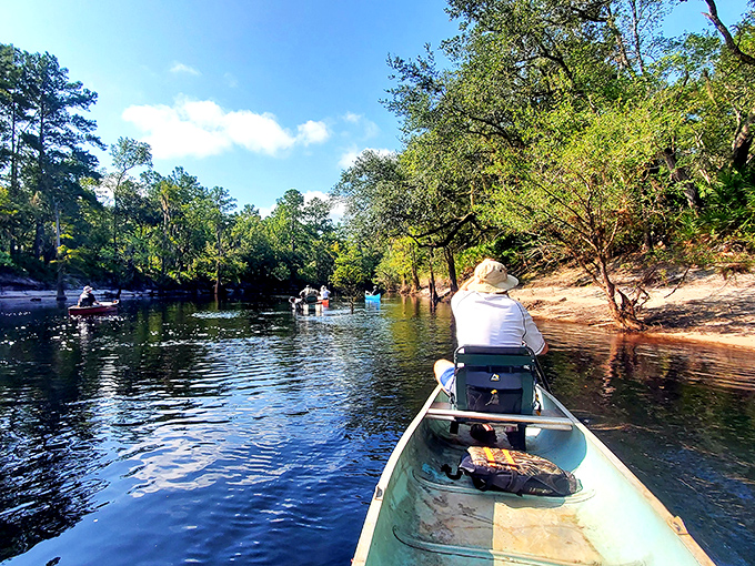 Explorers navigate the gentle current in traditional canoes &ndash; the same way travelers have experienced this river for generations.