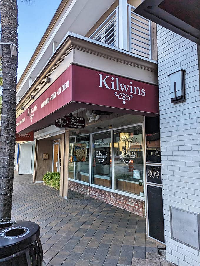 The traditional brick and awning design of Kilwins creates a timeless candy shop atmosphere.