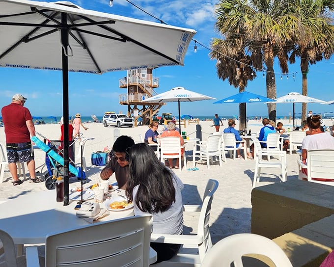 Beach dining in Anna Maria means umbrella-shaded tables where seafood tastes fresher and conversations flow easier with toes in the sand.