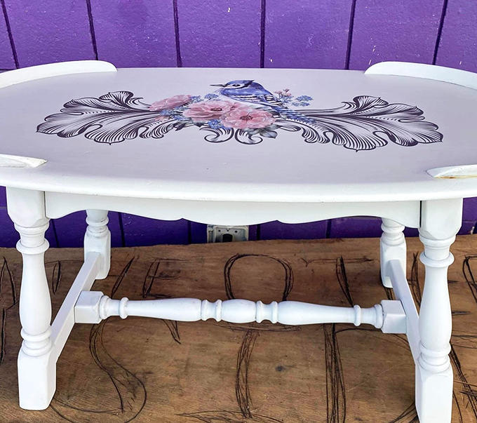 This isn't just a coffee table; it's a canvas featuring delicate bird artwork that somehow makes your coffee taste more sophisticated.