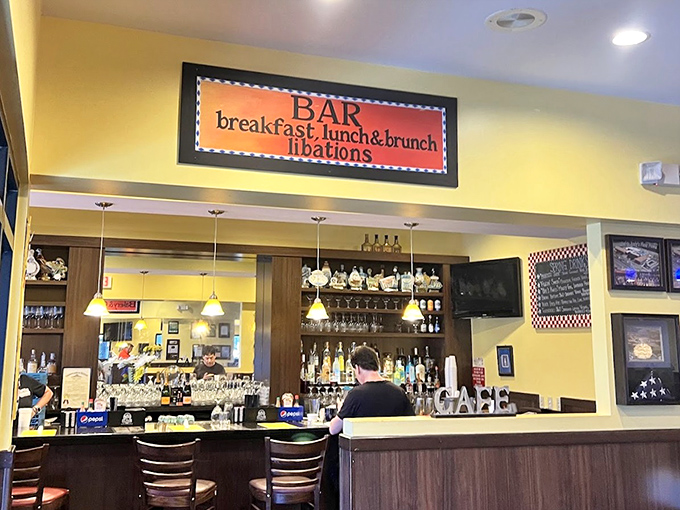 The bar area invites guests to enjoy breakfast cocktails and afternoon libations in a warm, neighborhood atmosphere.