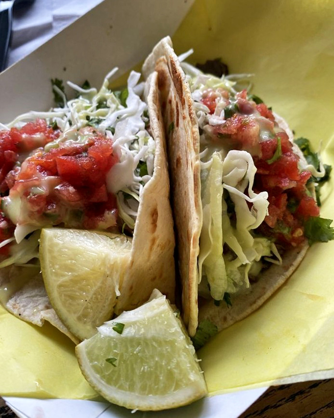 Barbacoa that's been slow-cooked until it surrenders completely, wrapped in a tortilla that's equally committed to its supporting role in this flavor drama.