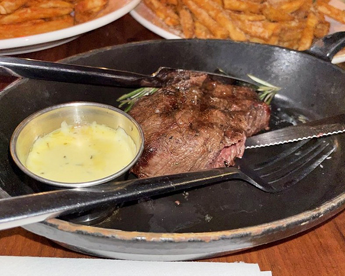 A steak that's seen just enough flame, served in cast iron with herb butter melting into a golden pool of "why aren't you here right now?"