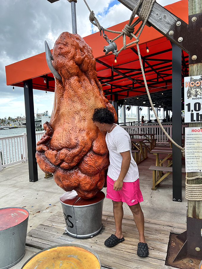 The wing's impressive scale transforms ordinary beachgoers into tiny human garnishes beside this colossal culinary creation.