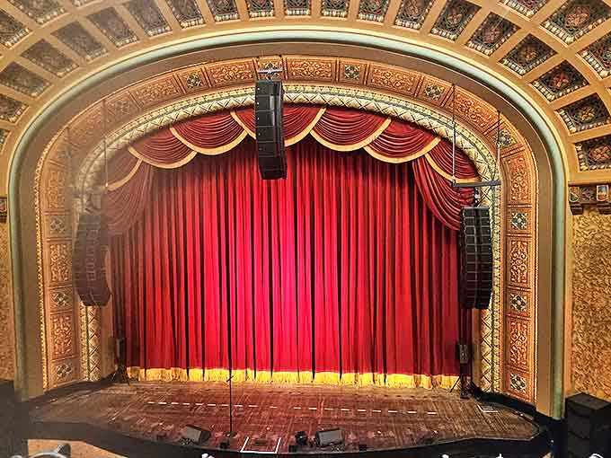 When the show concludes, the empty stage waits beneath the grand curtain, perhaps with an invisible audience of spirits still applauding from the shadows.
