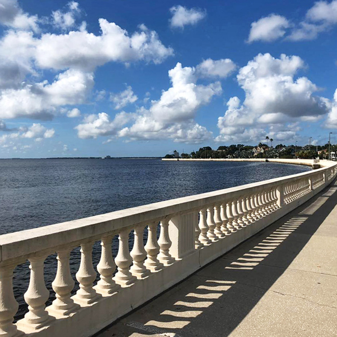 The curved balustrade creates a graceful boundary between land and water, its shadows creating ever-changing patterns throughout the day.