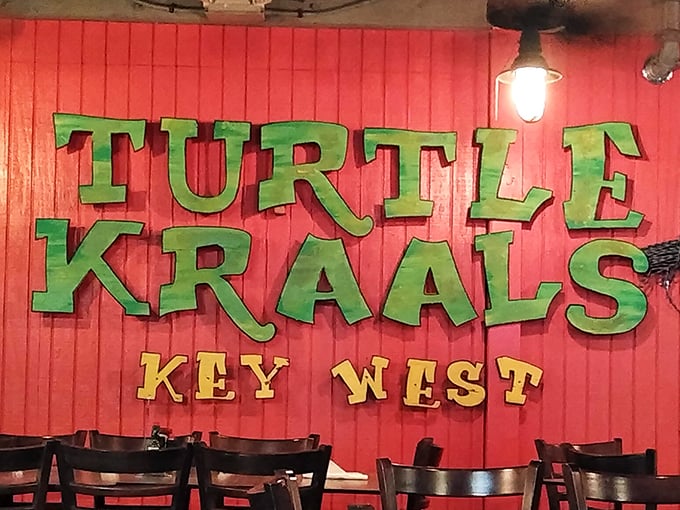 Bold green letters against weathered wood announce you've found the place where turtle races and tropical drinks create memories that last longer than your suntan.