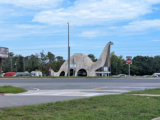 From across the intersection, the dinosaur garage stands as Spring Hill's most distinctive landmark, impossible to miss or forget.