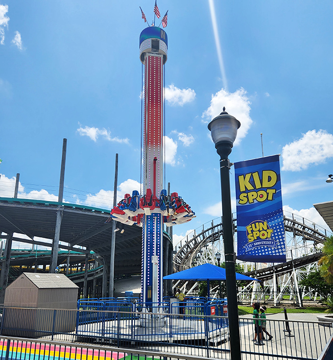 The drop tower stands tall against the blue Florida sky, a monument to that delicious moment when your stomach and your body briefly part ways.