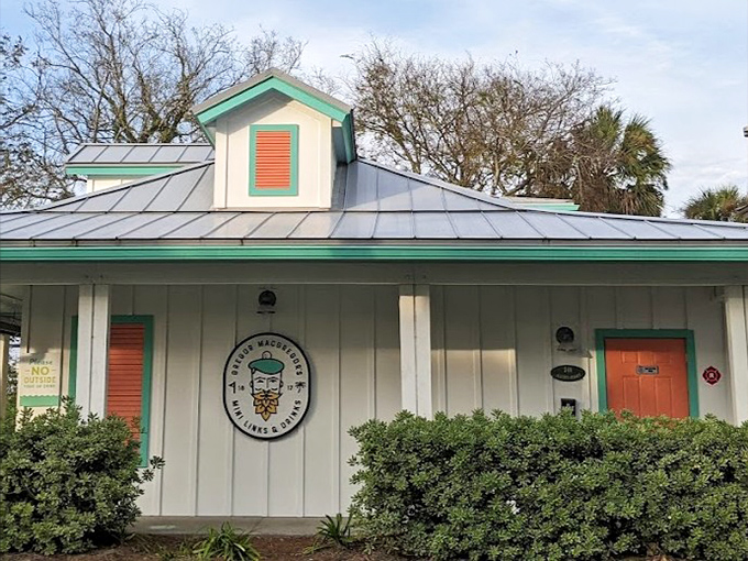 The charming coastal-inspired exterior welcomes visitors with its mint-green trim and promises of good times within.