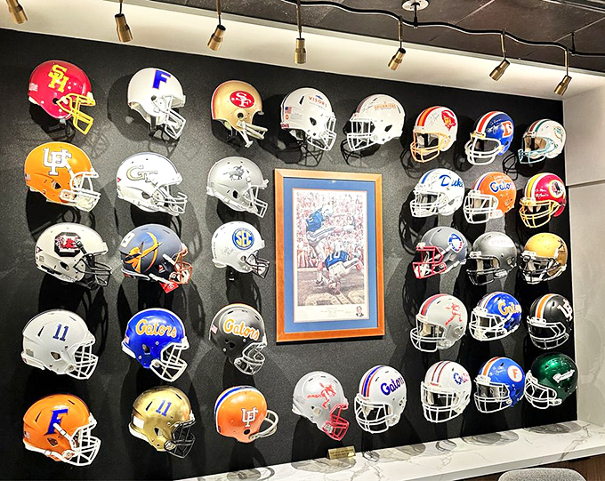 A museum-worthy collection of collegiate helmets creates a colorful backdrop celebrating the sport's heritage, with special prominence given to Florida's orange and blue glory.