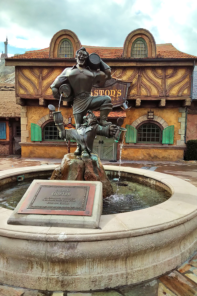Gaston's fountain offers a moment of refreshment before your underwater adventure. The only thing bigger than this statue is his ego.