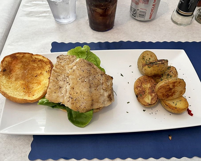 Perfectly seasoned fish meets crisp lettuce on toasted bread – proving sometimes the simplest preparations are the most satisfying.
