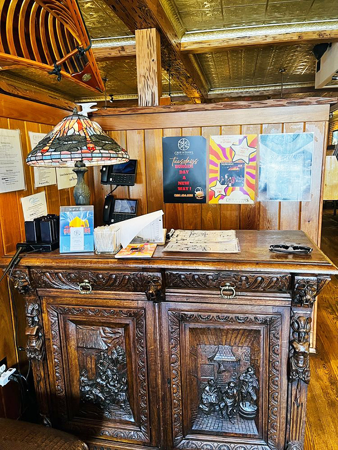 The host station's intricately carved antique desk sets the tone for your visit – this is a place that appreciates history and craftsmanship.