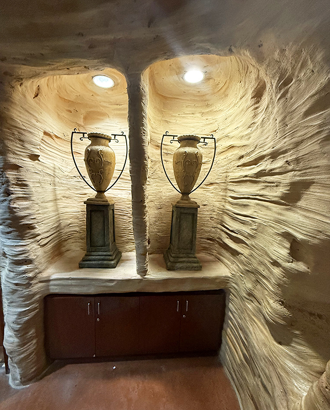 Classical urns stand sentinel in carved niches &ndash; even the smallest details maintain the mythological immersion throughout the space.