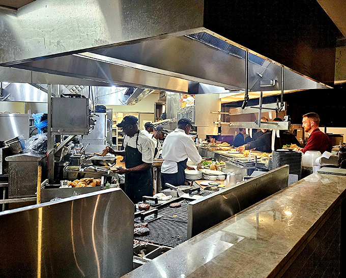 The kitchen operates with the organized chaos of a symphony &ndash; each station a hub of focused activity creating edible masterpieces with military precision.