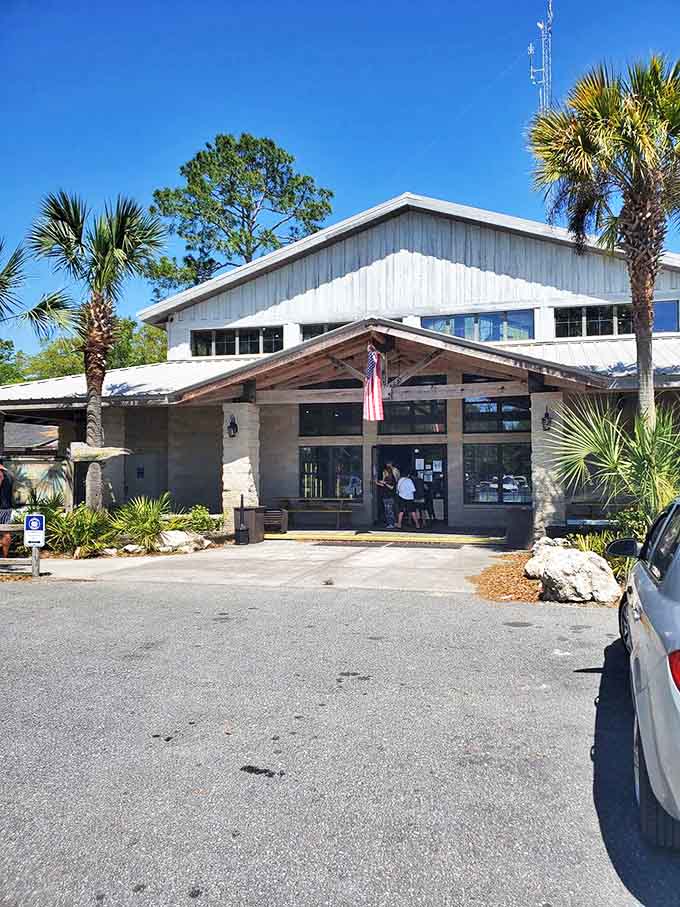 The main building welcomes visitors with Florida charm &ndash; palm trees included at no extra charge.