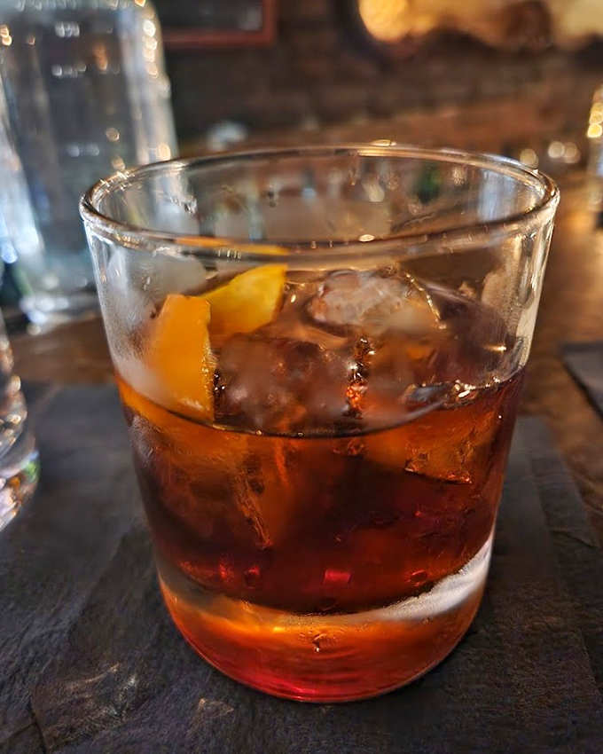 A classic Negroni served in this atmosphere tastes exactly how it did when your great-grandparents were sneaking into speakeasies during Prohibition.