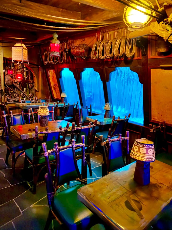 Dining here feels like eating inside a luxury treehouse designed by someone who really, really loves blue lighting and waterfalls.