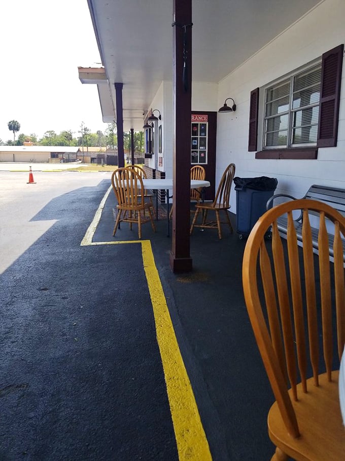 Simple wooden chairs under the awning offer fresh air dining. Sometimes barbecue tastes even better with a side of Florida sunshine.